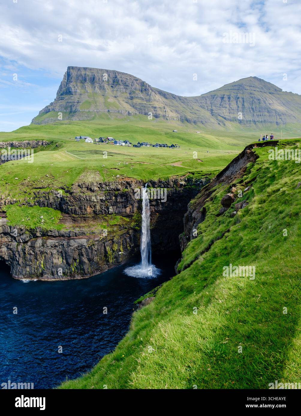 Experience Stunning Gasadalur Waterfall Cascading Hi Res Stock