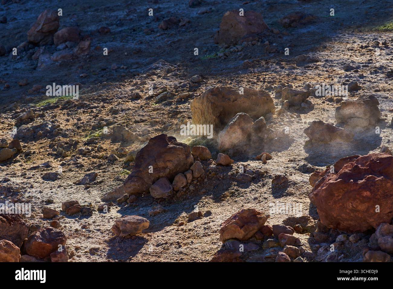Steam and sulphur fumes rising from fumaroles and rocks inside the ...