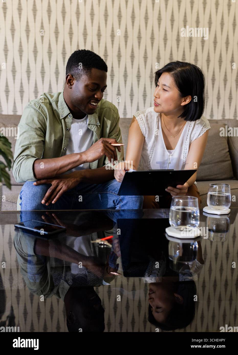 Diverse coworkers reviewing document table hi-res stock photography and ...