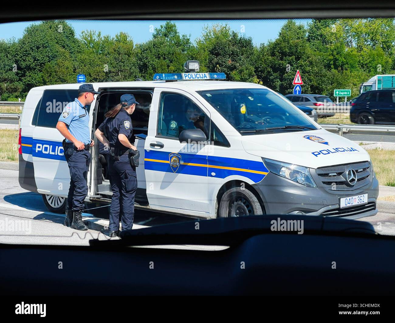 Zagreb, Croatia - August 25, 2025: Croatian officers interact beside ...