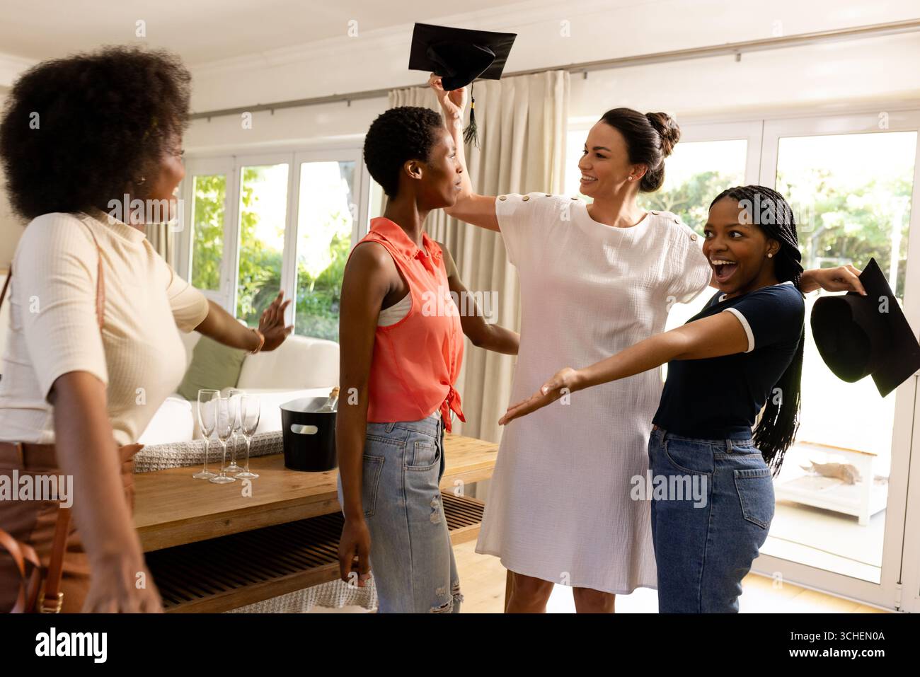 Diverse female friends celebrating graduation hi-res stock photography ...