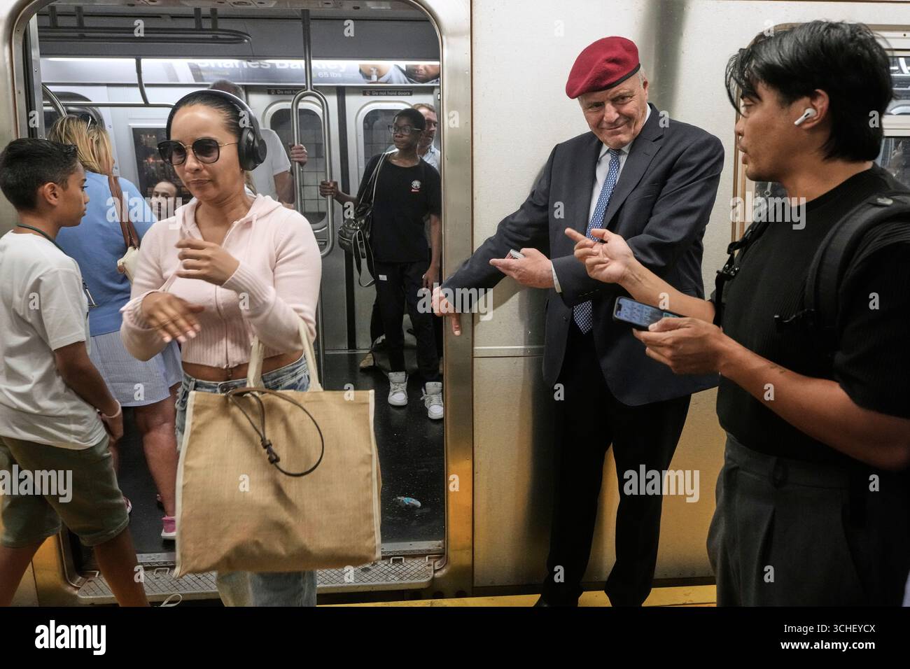 New York Mayor candidate Curtis Sliwa holds a subway door for a ...
