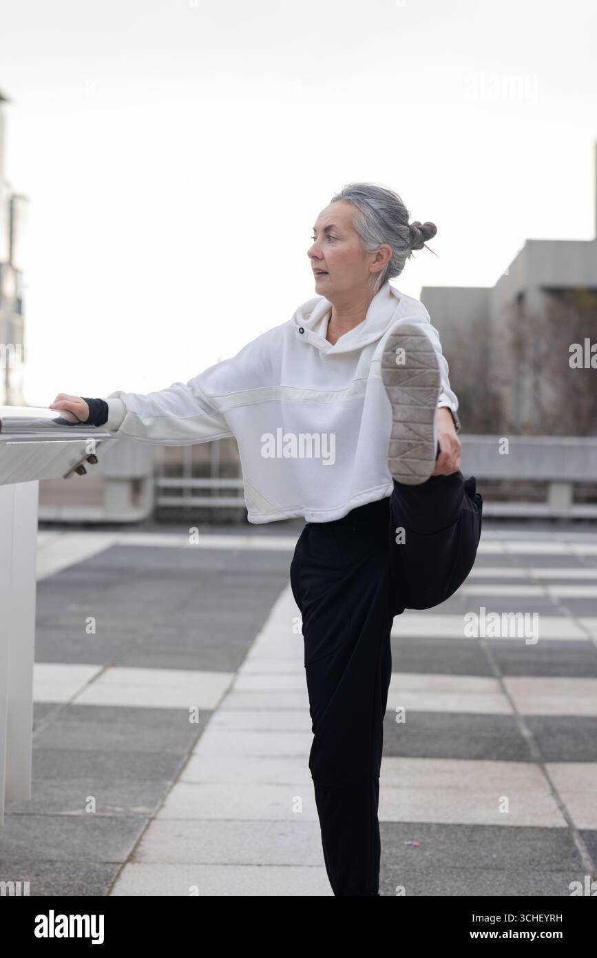 Woman performing hamstring stretch in hi-res stock photography and ...