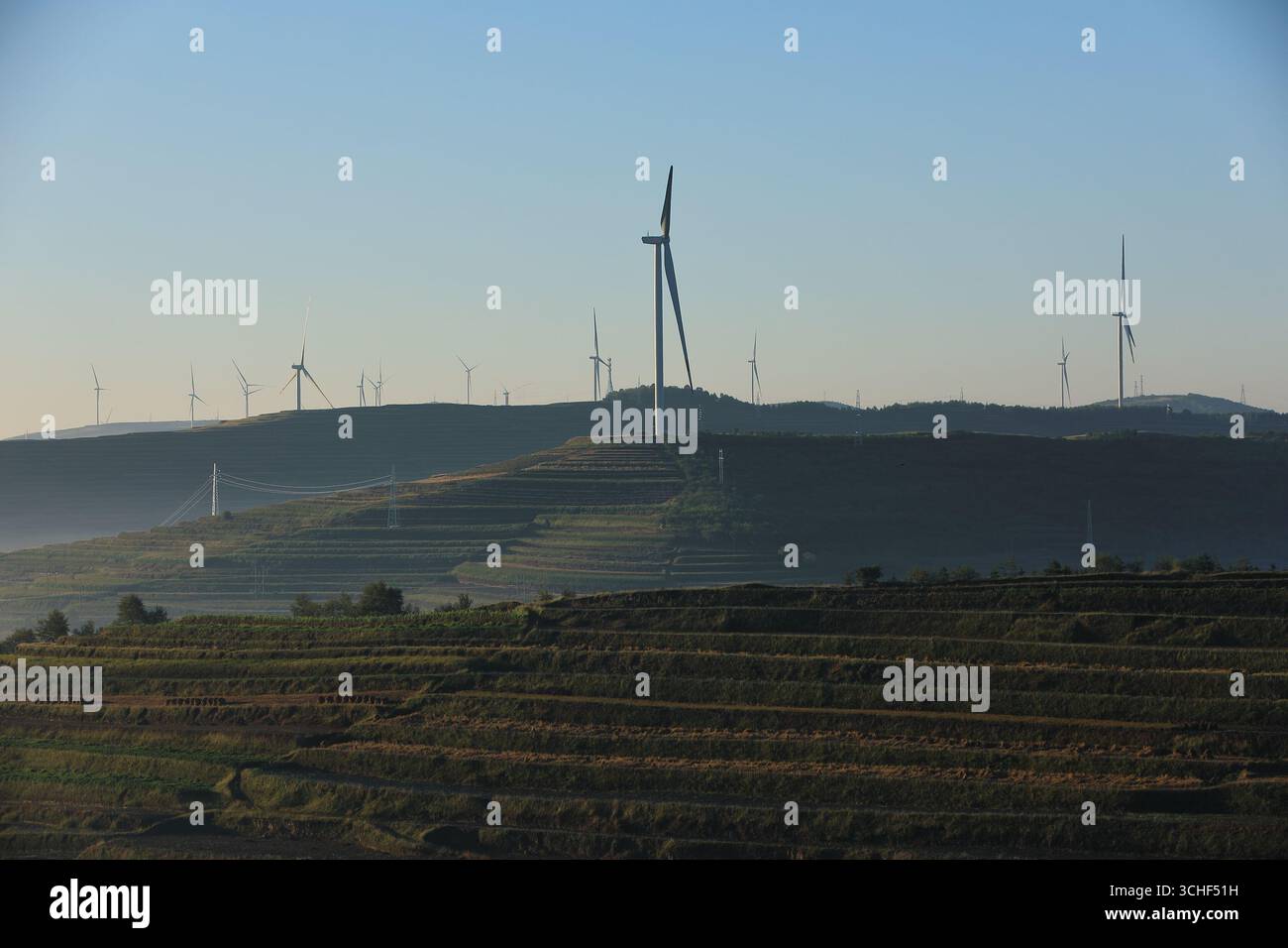 DINGXI, CHINA - AUGUST 31, 2025 - Terraced fields and wind turbines ...
