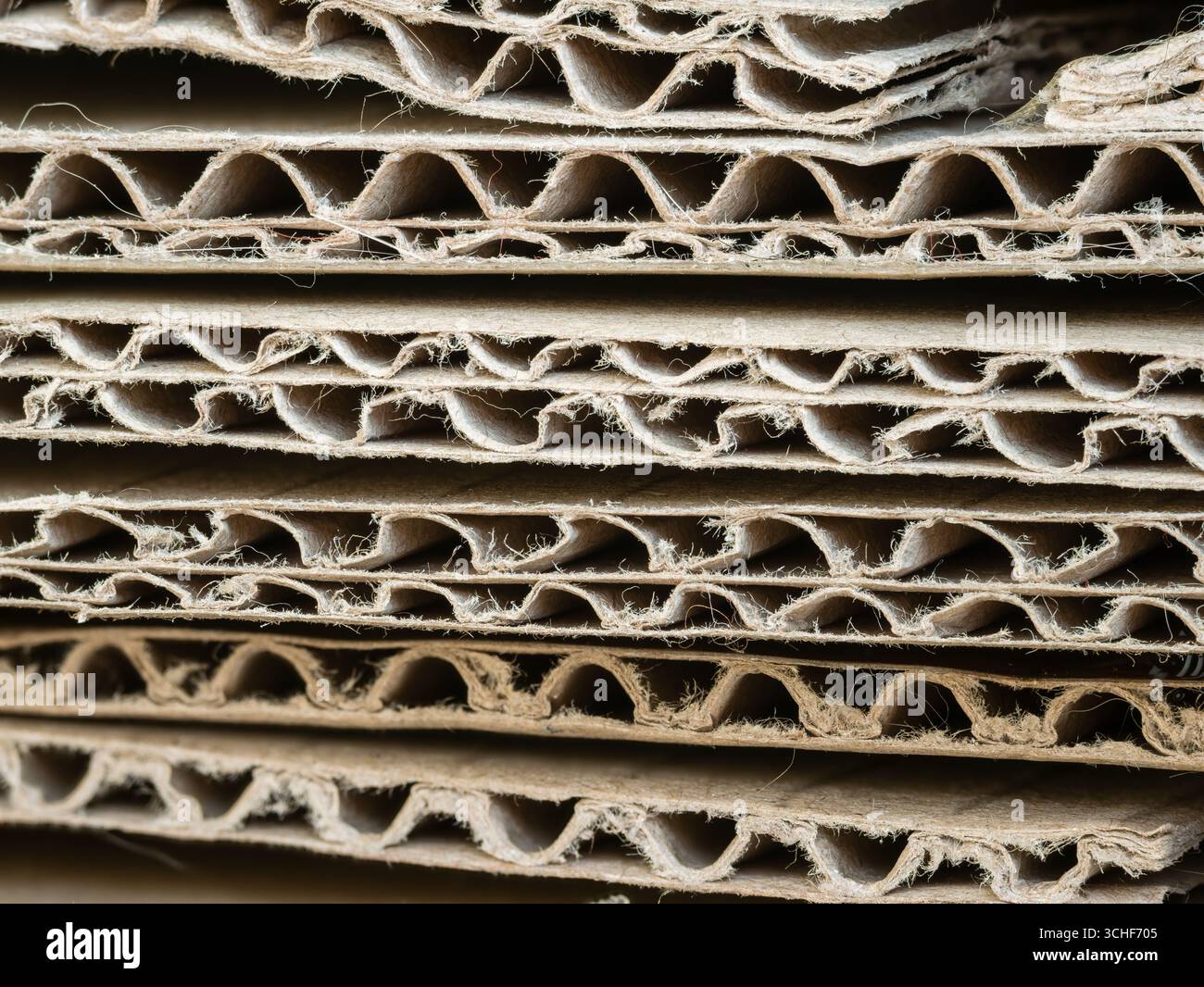 Macro photo of a stack of thick corrugated cardboard sheets. Background ...