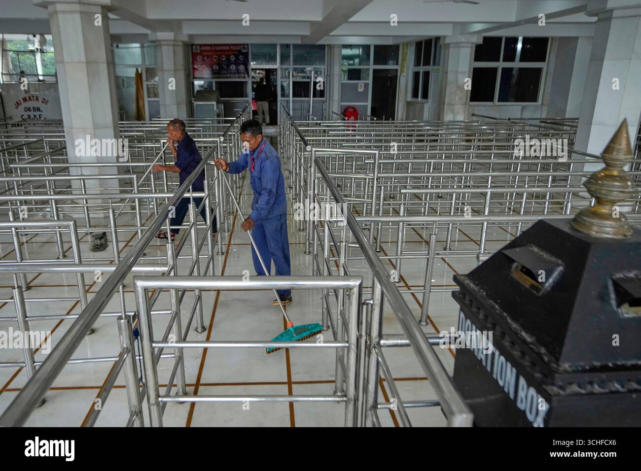 Workers clean the deserted Ban Ganga entrance for the holy Vaishno Devi ...