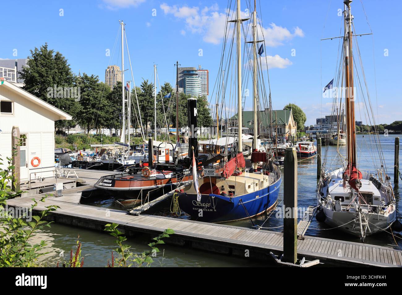 Boats in Veerhaven dock in Rotterdam, with the skyscrapers of Zuid ...