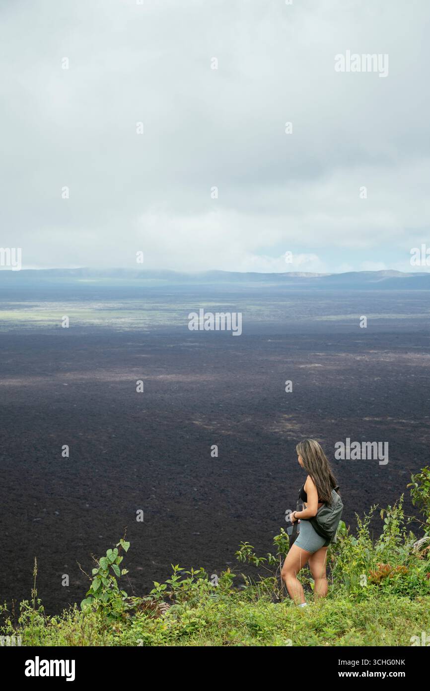 Hiker enjoying view on Sierra Negra volcano, Isabela Island, Galapagos ...