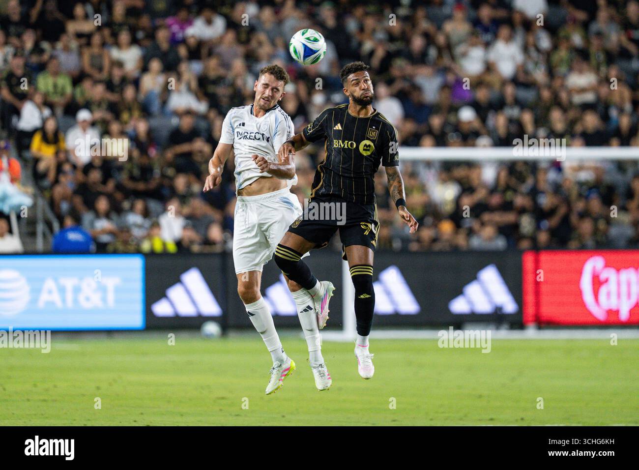 LAFC forward Denis Bouanga (99) and San Diego FC defender Christopher McVey (97) jump for a ball ...