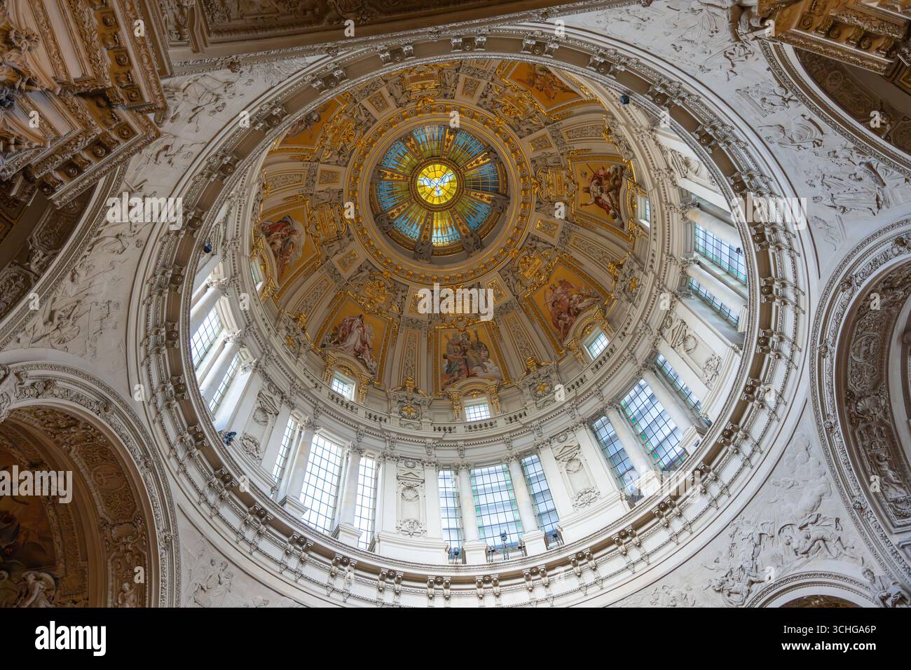 Ornate dome ceiling inside Berlin Cathedral with stained glass. Gold ...