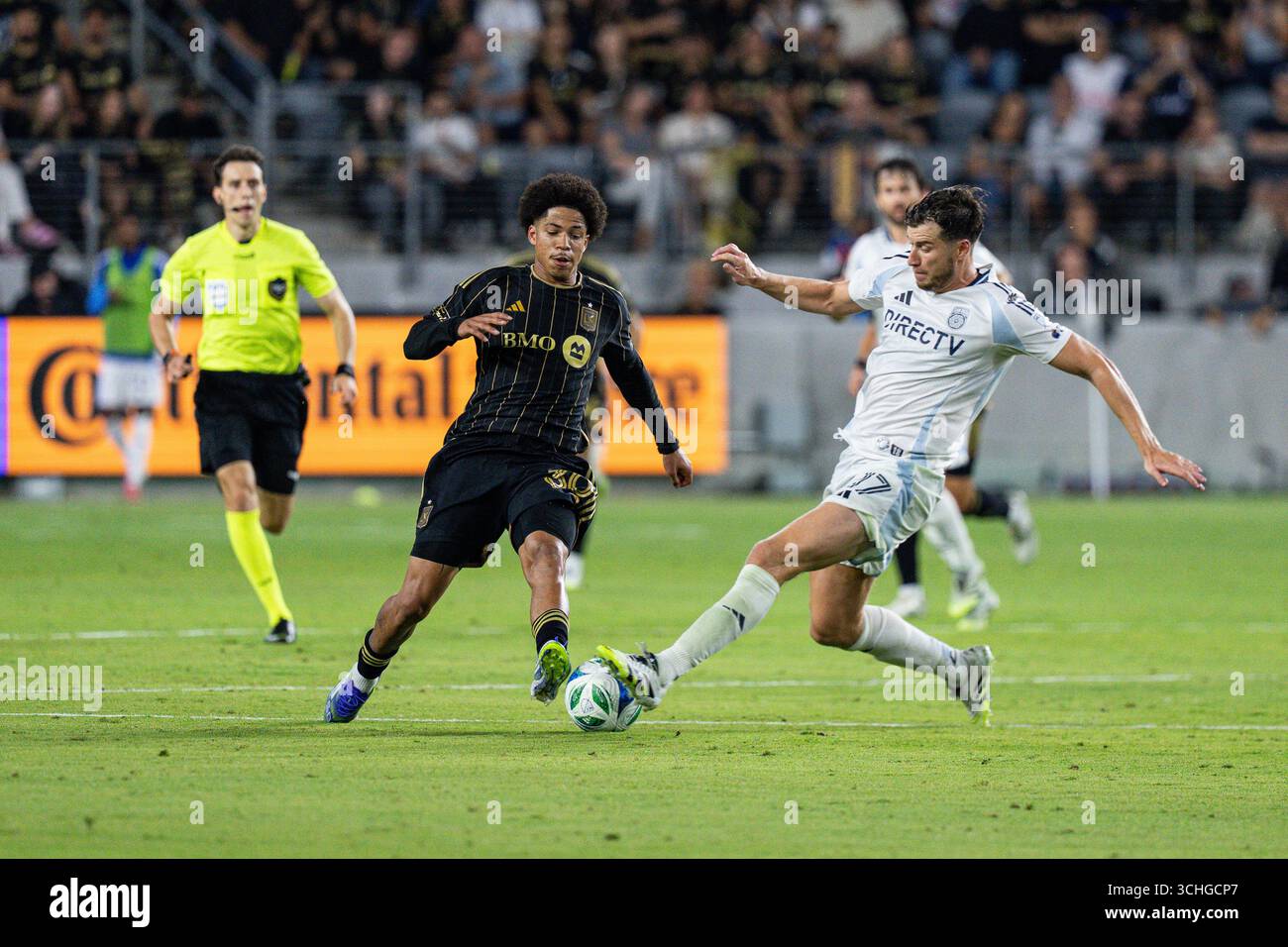 LAFC forward David Martínez (30) is slide tackled by San Diego FC defender Paddy McNair (17 ...