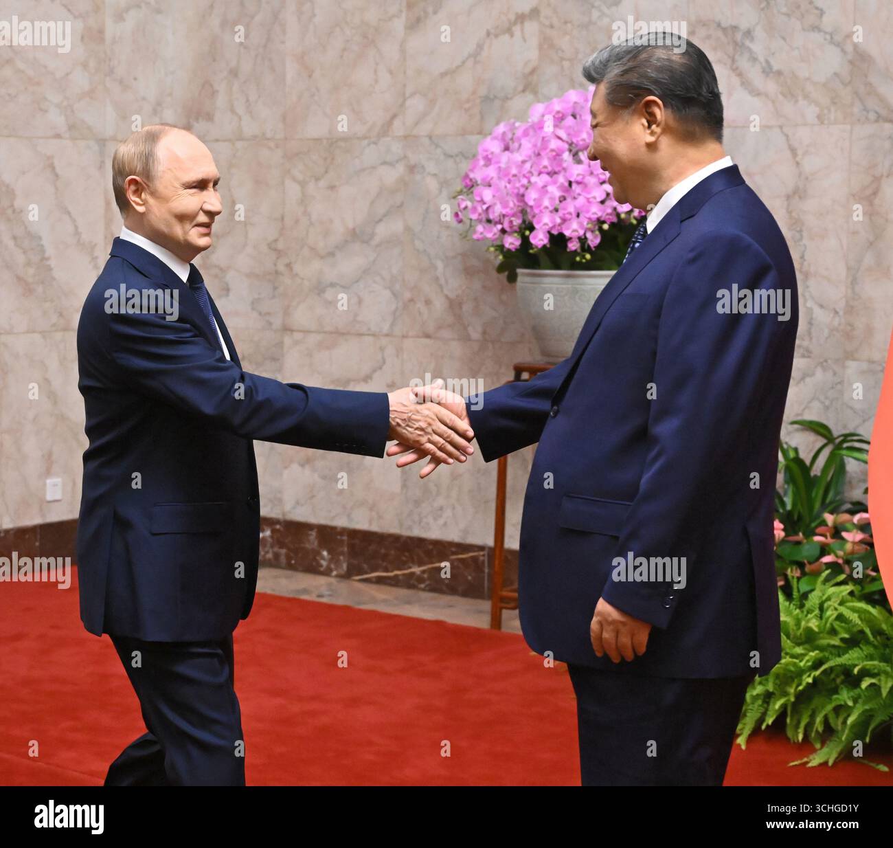 Russian President Vladimir Putin (left) and President of the People's ...