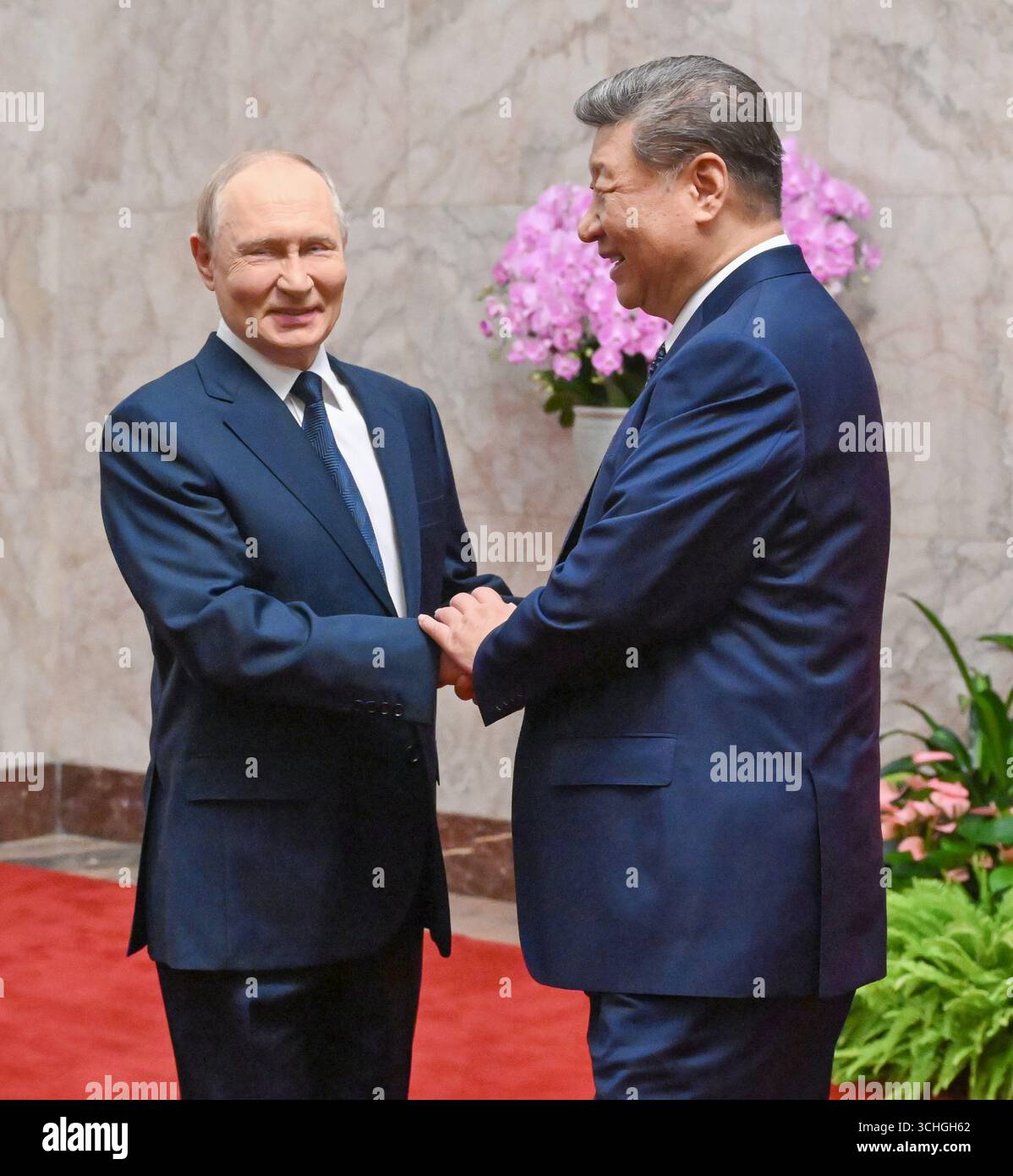 Russian President Vladimir Putin (left) and President of the People's ...