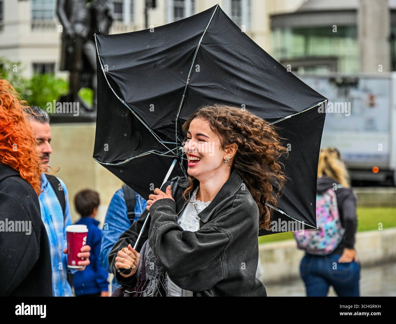 London, UK. 2 Sep 2025. Keeping control of umbrellas in teh gusty wind is not always successful ...