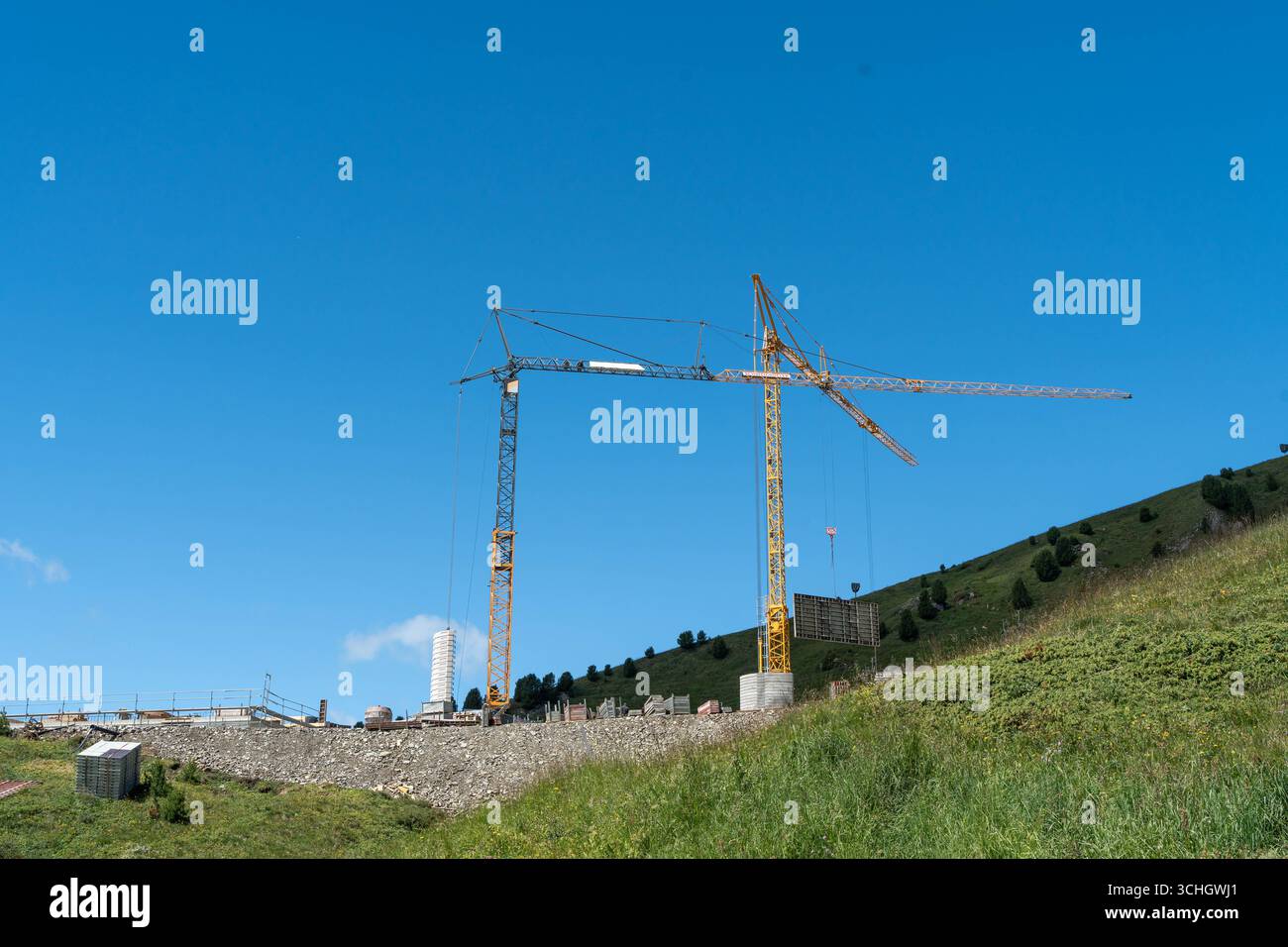 Scenic Dolomites mountains with green meadows, pine forest, and a ...