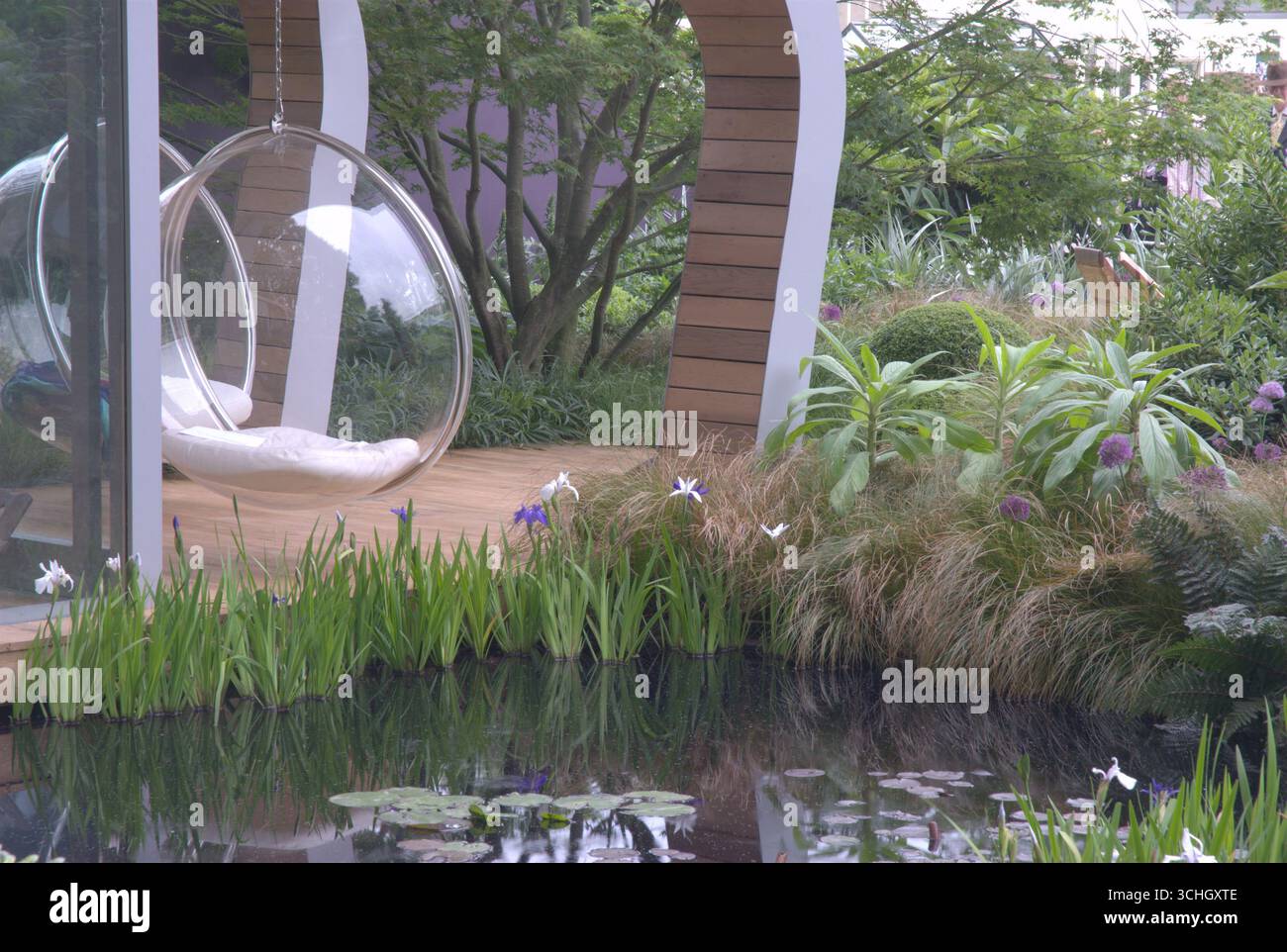 Visitors admire the elegant garden design showcasing a clear hanging ...