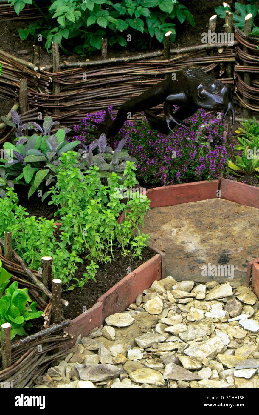 A vibrant garden features a stone pathway bordered by plants and a ...