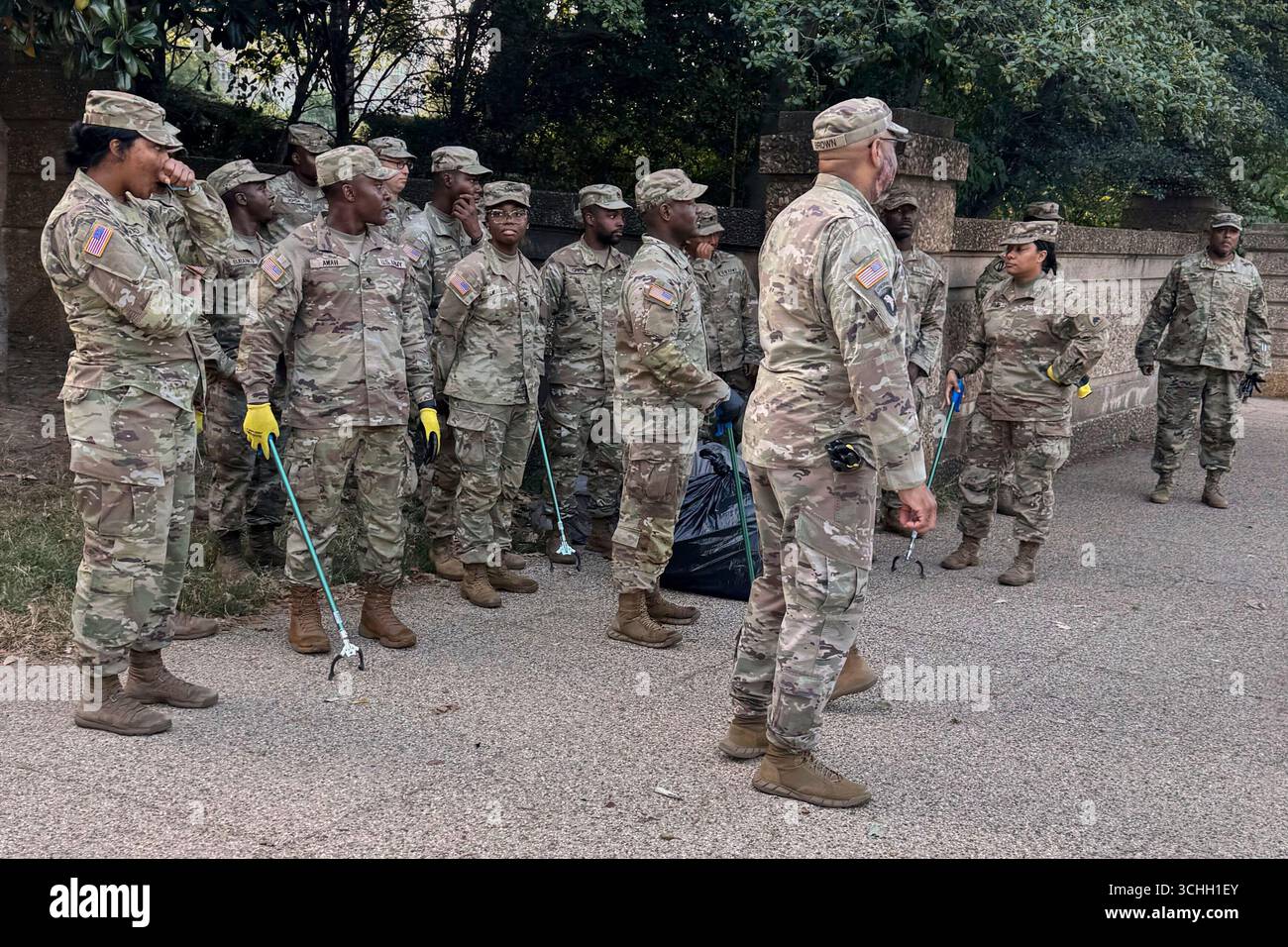 National Guard with tools to pick up trash are seen Tuesday, Sept. 2 ...