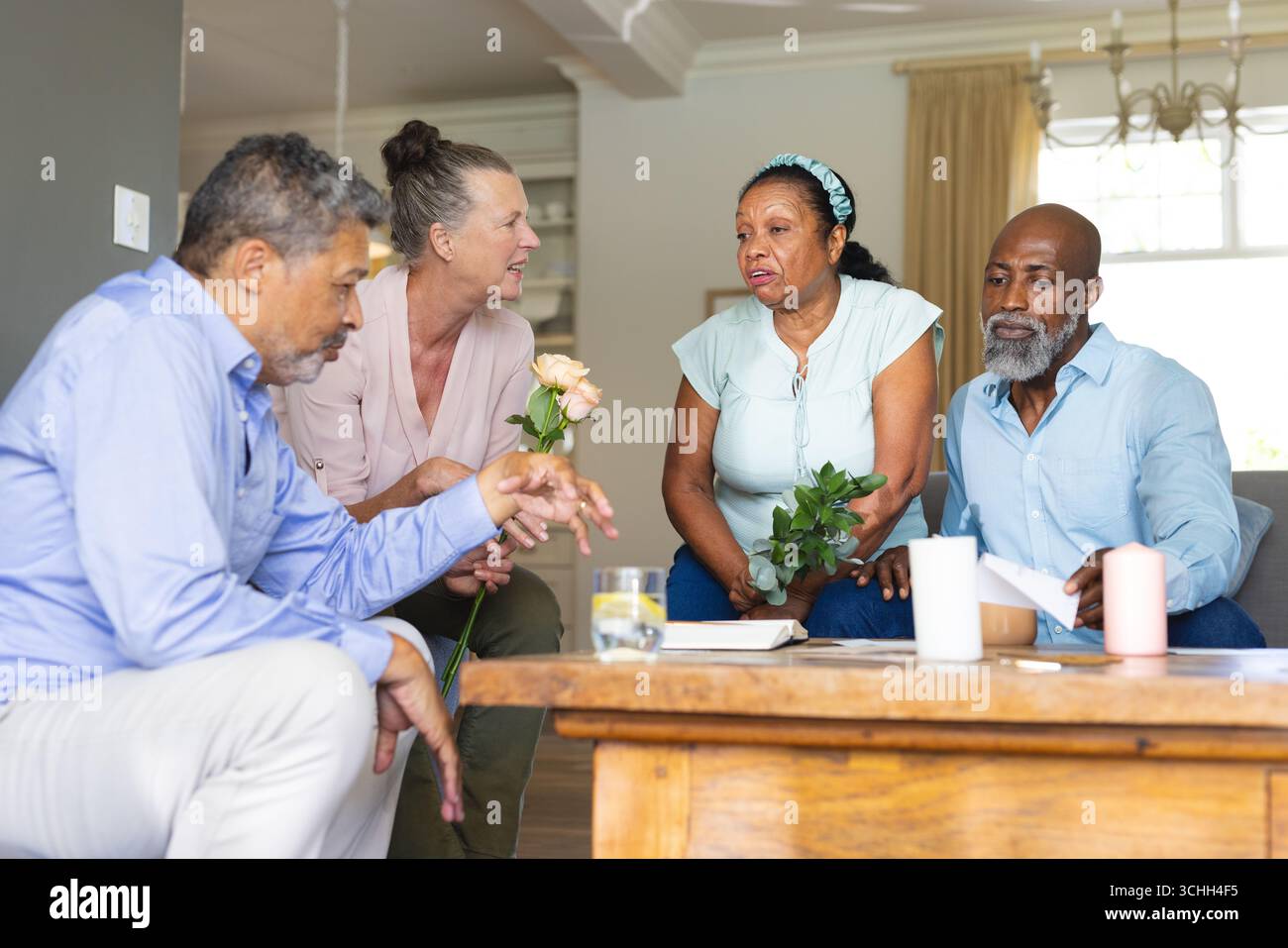Diverse family enjoying gathering discussing hi-res stock photography ...