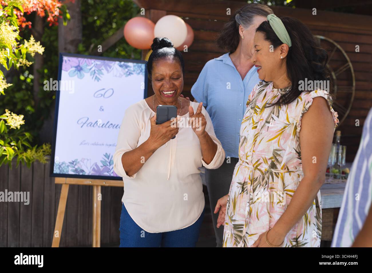 Celebrating 60th birthday, African American woman joyfully sharing ...