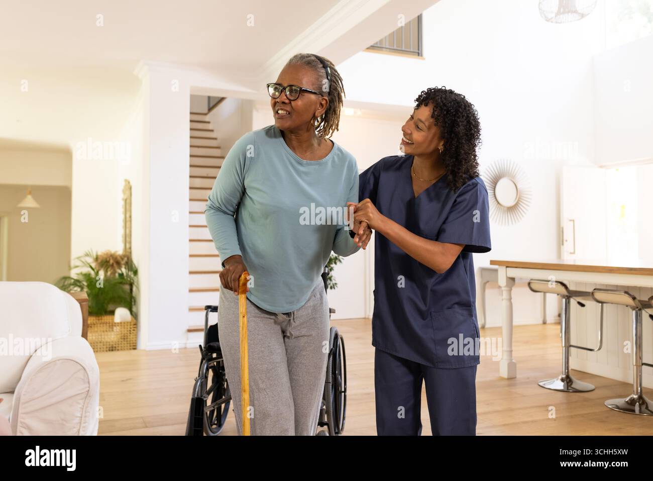 Supportive caregiver assisting senior woman hi-res stock photography ...