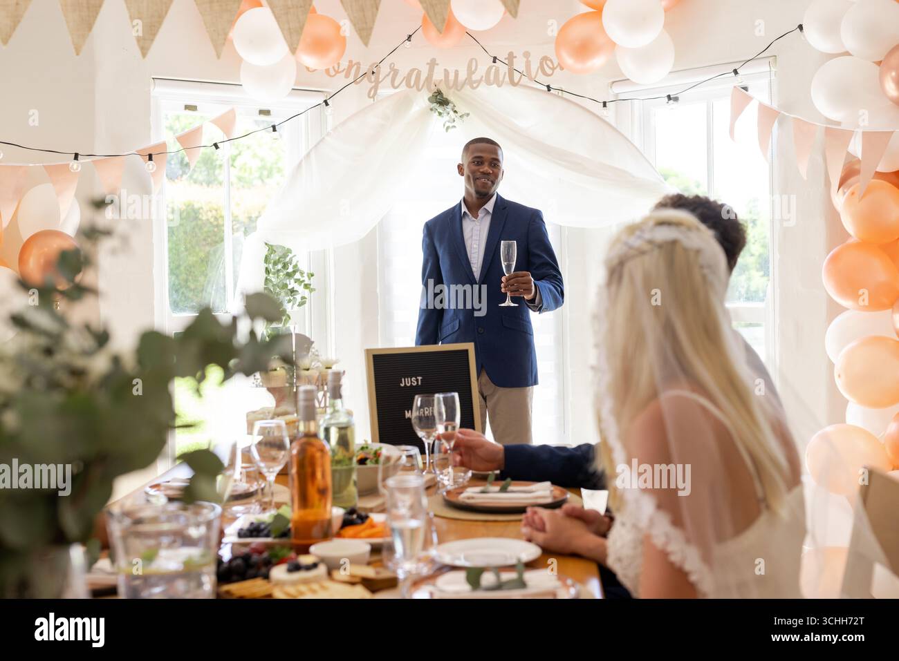 Groom giving heartfelt toast at elegant wedding reception with friends ...
