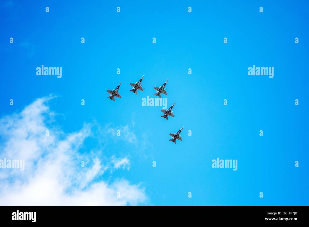 A fleet of five military fighter aircraft flying in tight formation ...