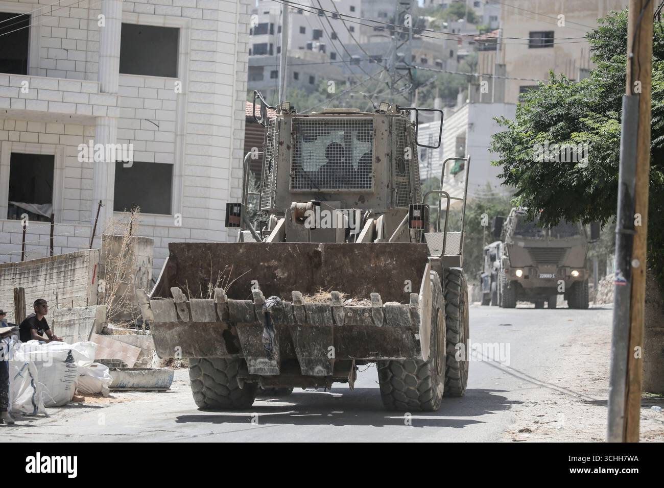 An Israeli military bulldozer seen moving in the village of Kafr Qalil ...