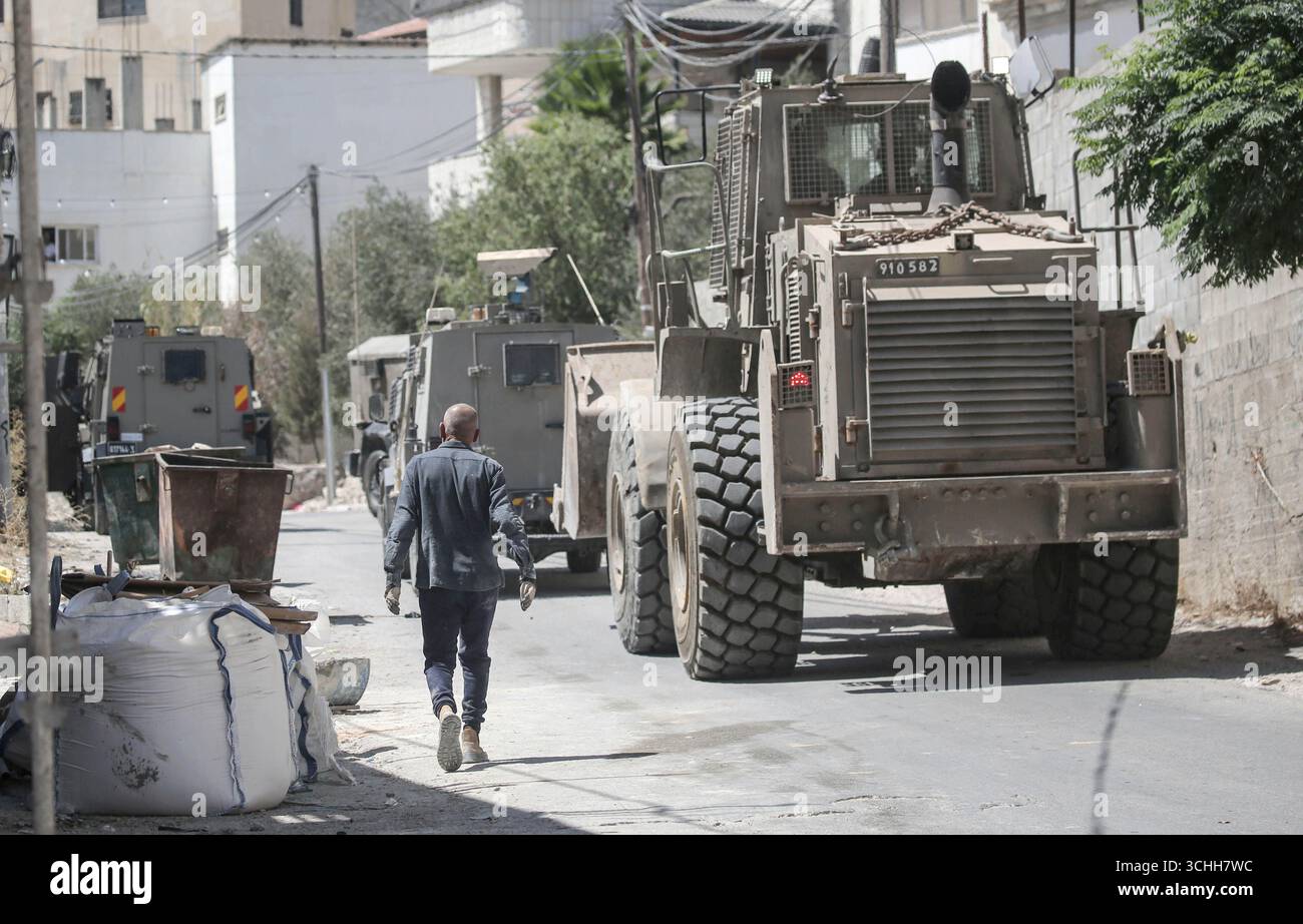 An Israeli military bulldozer seen moving in the village of Kafr Qalil ...