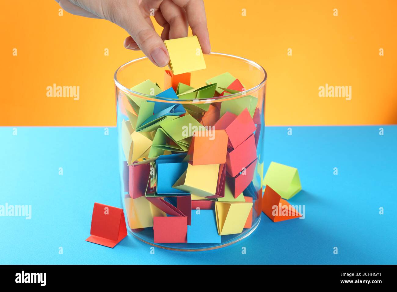 Woman taking yellow paper piece hi-res stock photography and images - Alamy