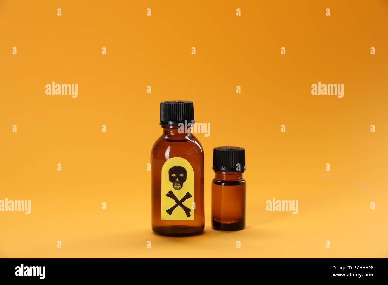 Bottles of poisons with warning sign on orange background Stock Photo ...