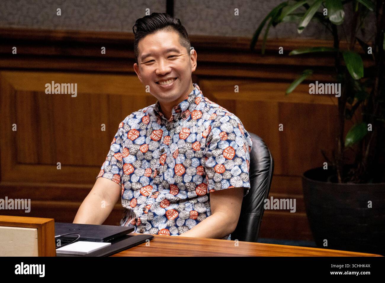 State Sen. Stanley Chang, D-Honolulu, smiles while listening to a colleague at the state Capitol ...