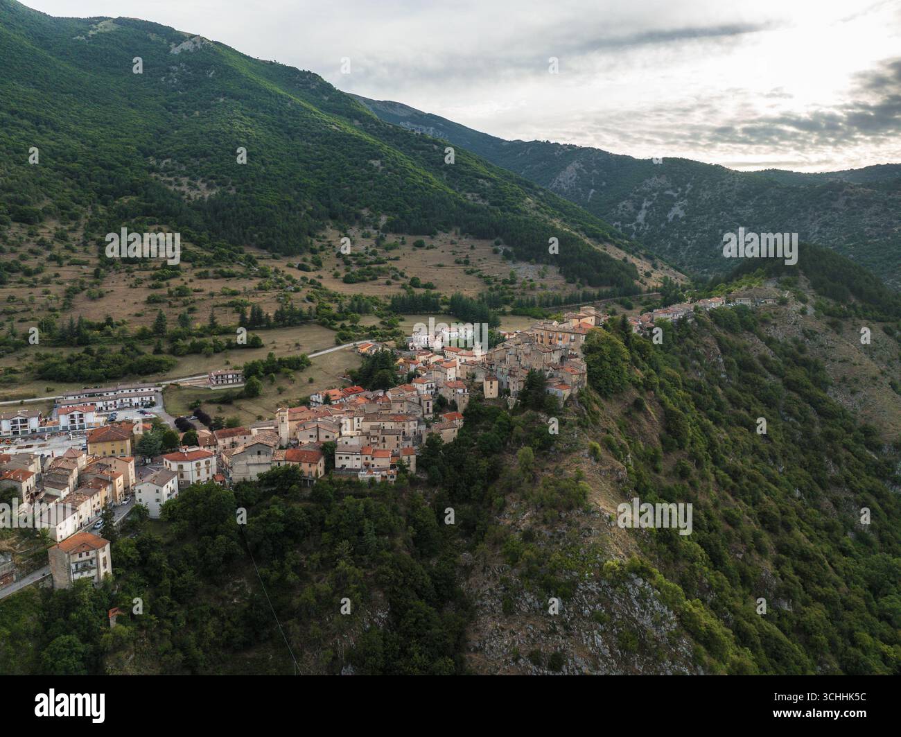 Aerial view of a village with terracotta rooftops nestled between ...