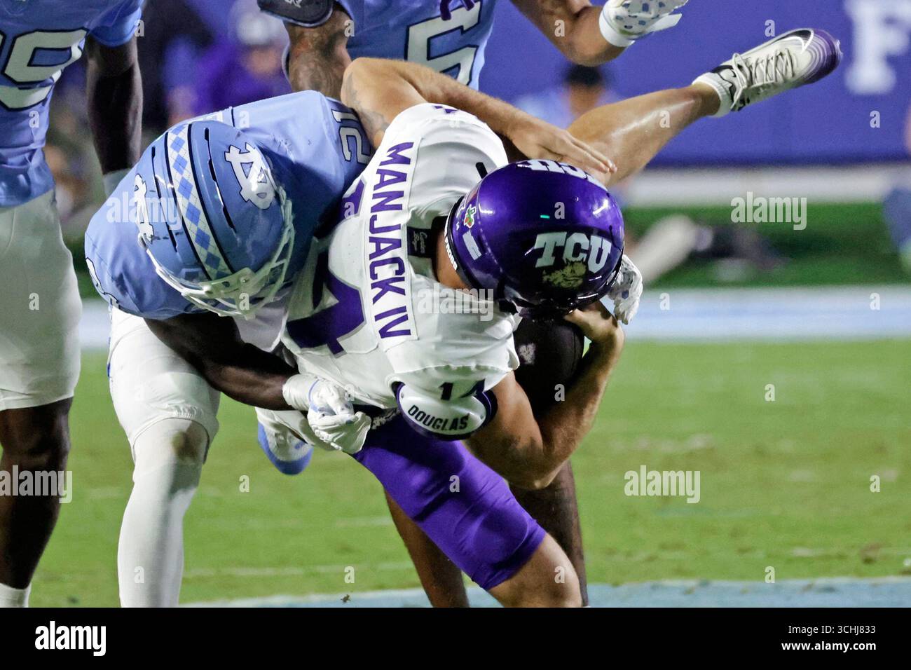 North Carolina defensive back Kaleb Cost (21) tackles TCU wide receiver ...