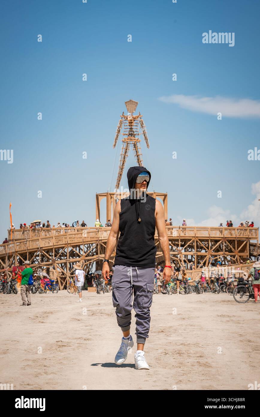 Man Walking Near Iconic Wooden Structure at Burning Man Festival Stock ...