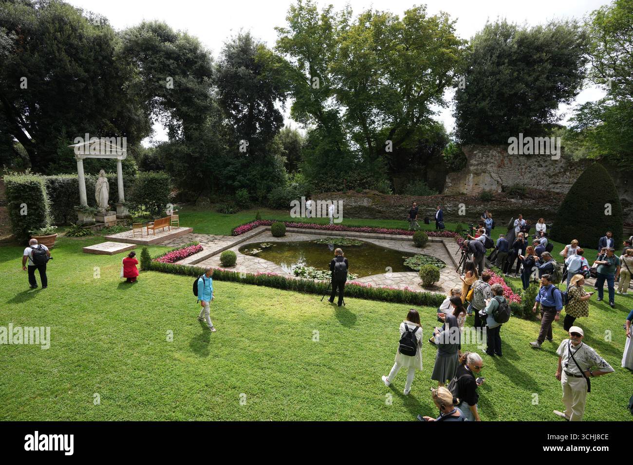 Journalists scan the place where popes gather to pray in front of a statue of the 'Our lady of ...