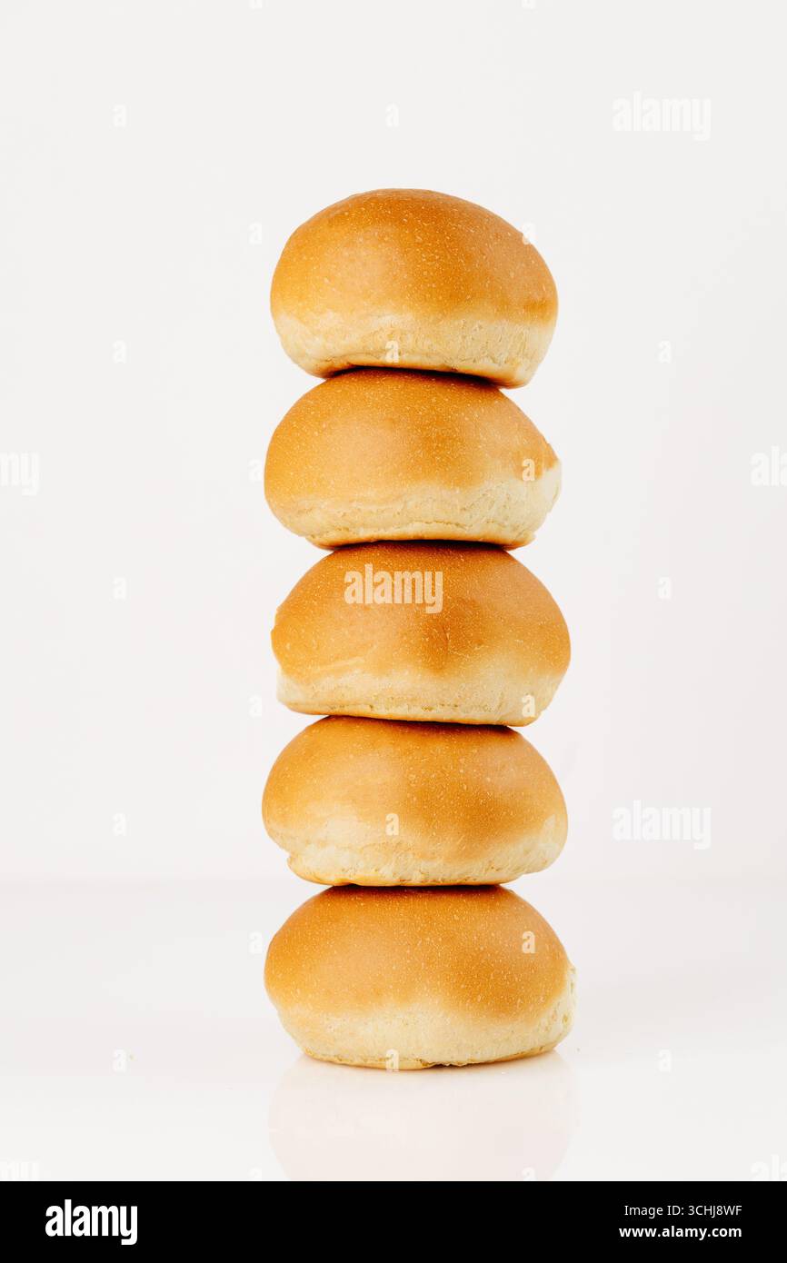 Stack of fresh round burger buns isolated on white background, front ...