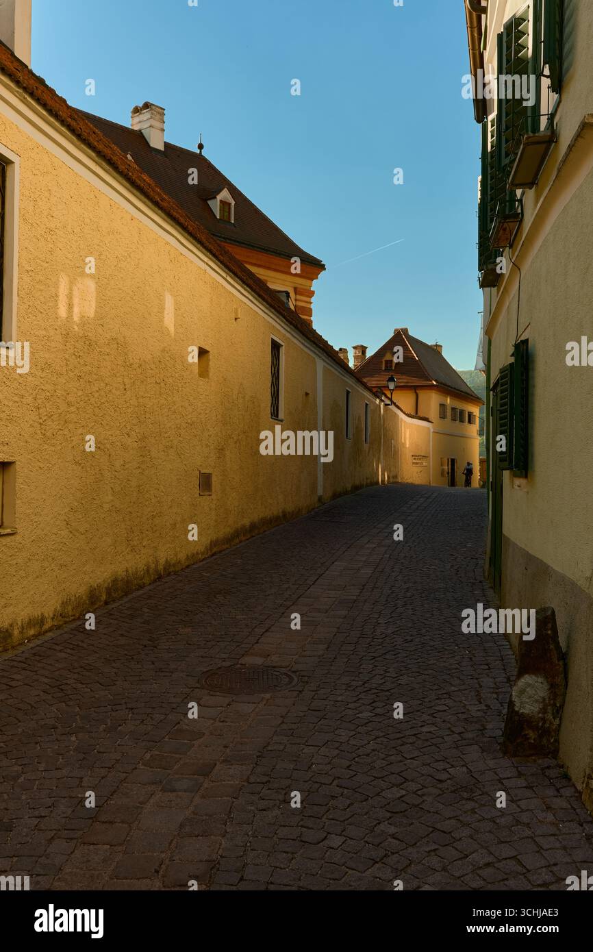 View of a cobblestone street in Dürnstein, Austria, featuring a long ...