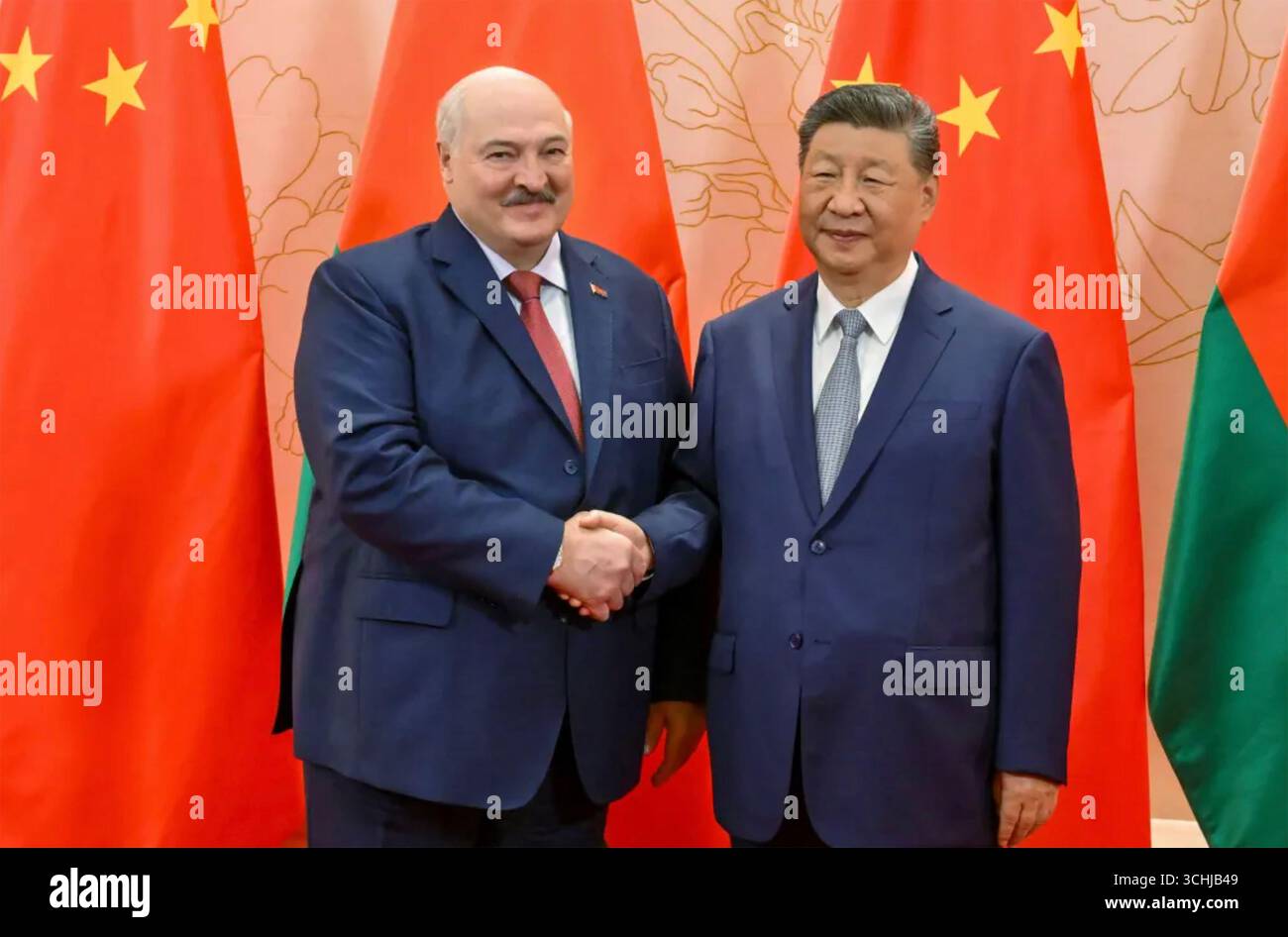 ALEXANDER LUKASHENKO, President of Belarus, at left shakes hands with ...