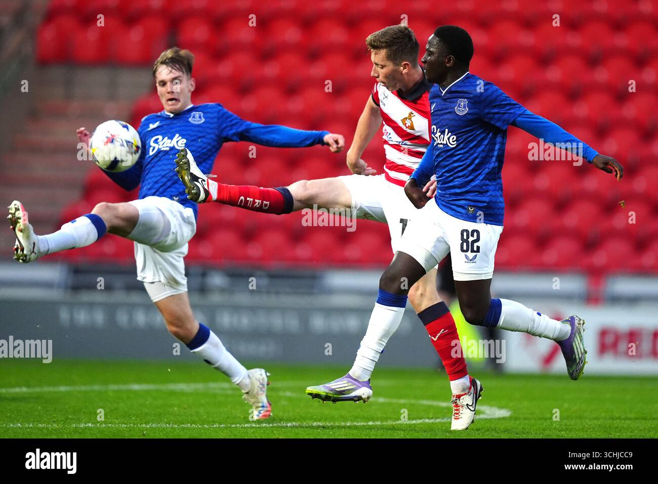 Doncaster Rovers' Harry Clifton (centre) battles for the ball with ...