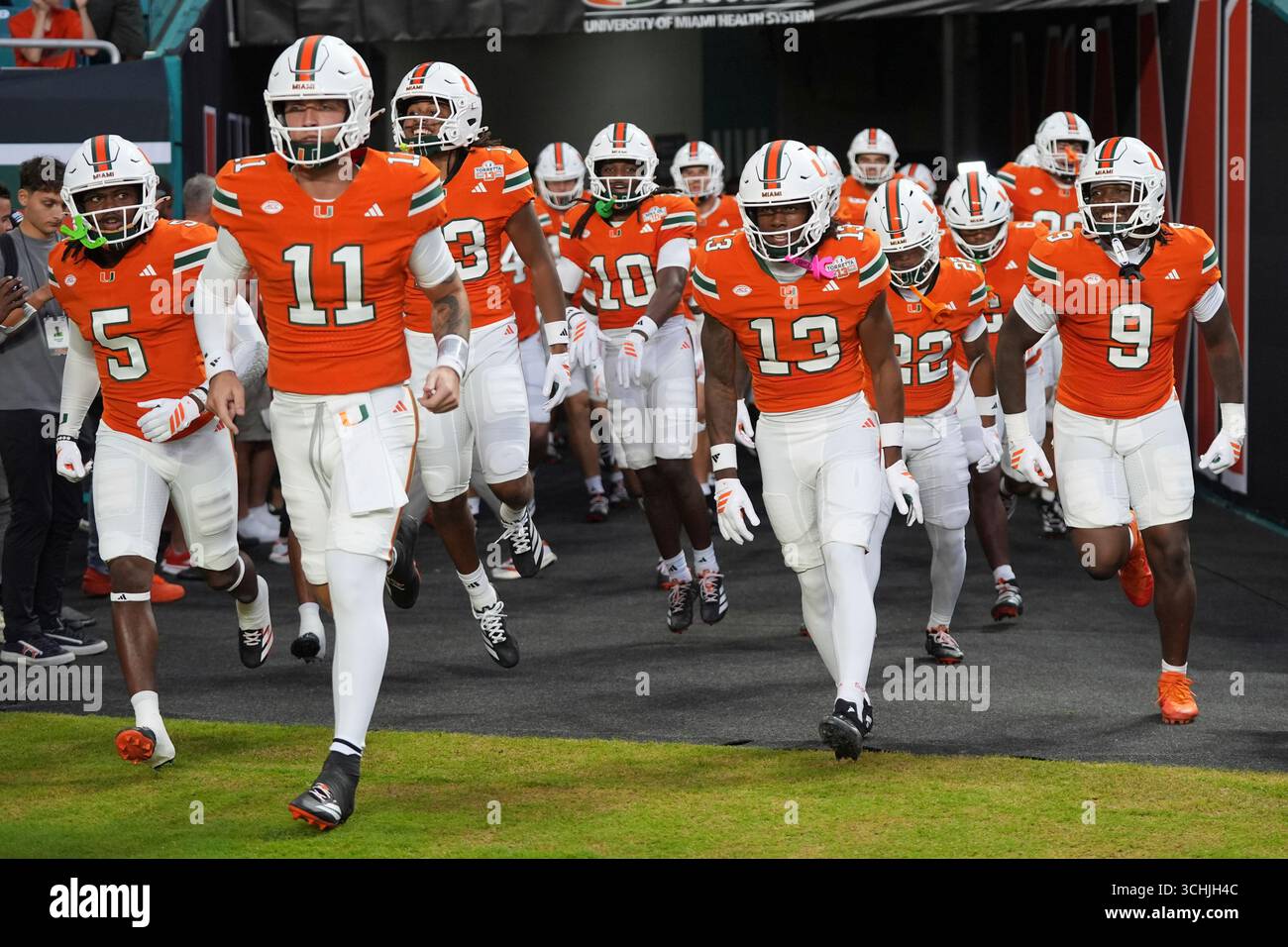 Miami quarterback Carson Beck (11) leads players onto the field before ...