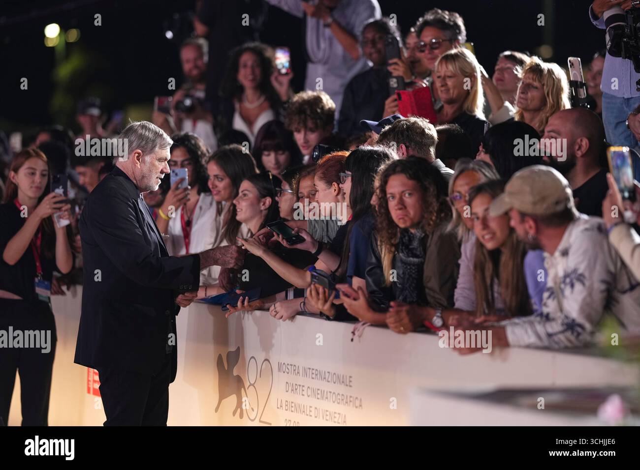 Director Gus Van Sant signs autographs upon arrival at the red carpet ...