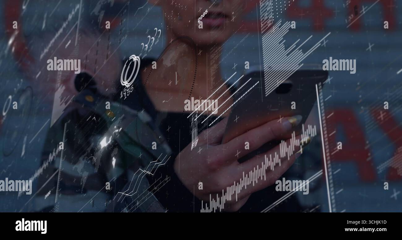 Standing woman in black top holding smartphone at graffiti wall ...