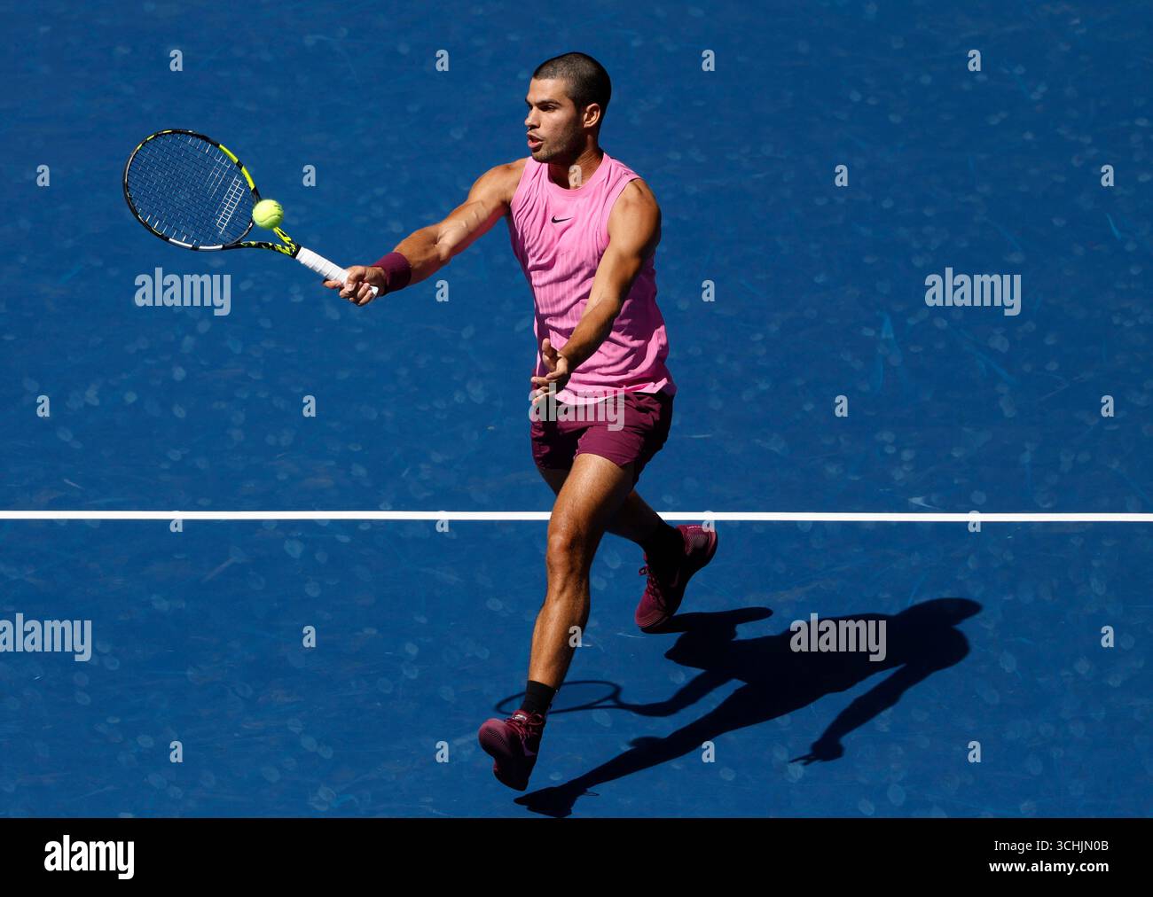 Carlos Alcaraz of Spain hits a volley at net to Jiri Lehecka of Czechia ...