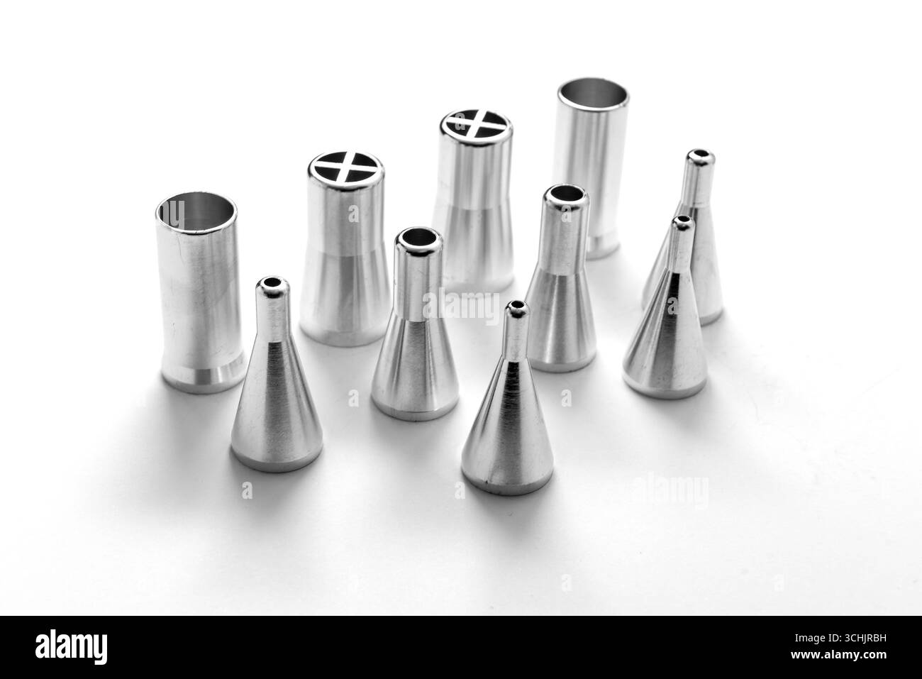 Close-up of stainless steel solder dispensing nozzles on white ...