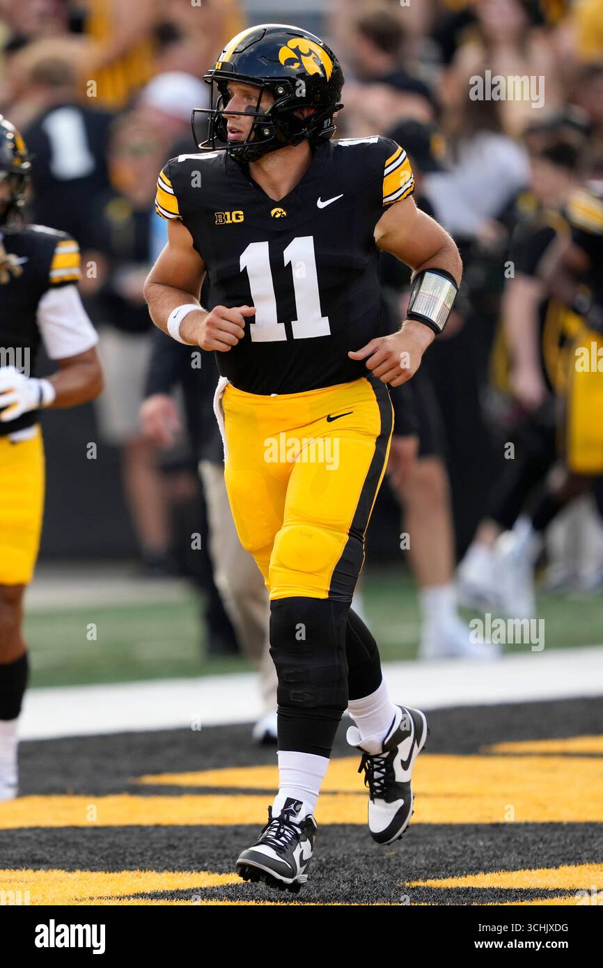 Iowa quarterback Mark Gronowski (11) runs onto the field before an NCAA ...