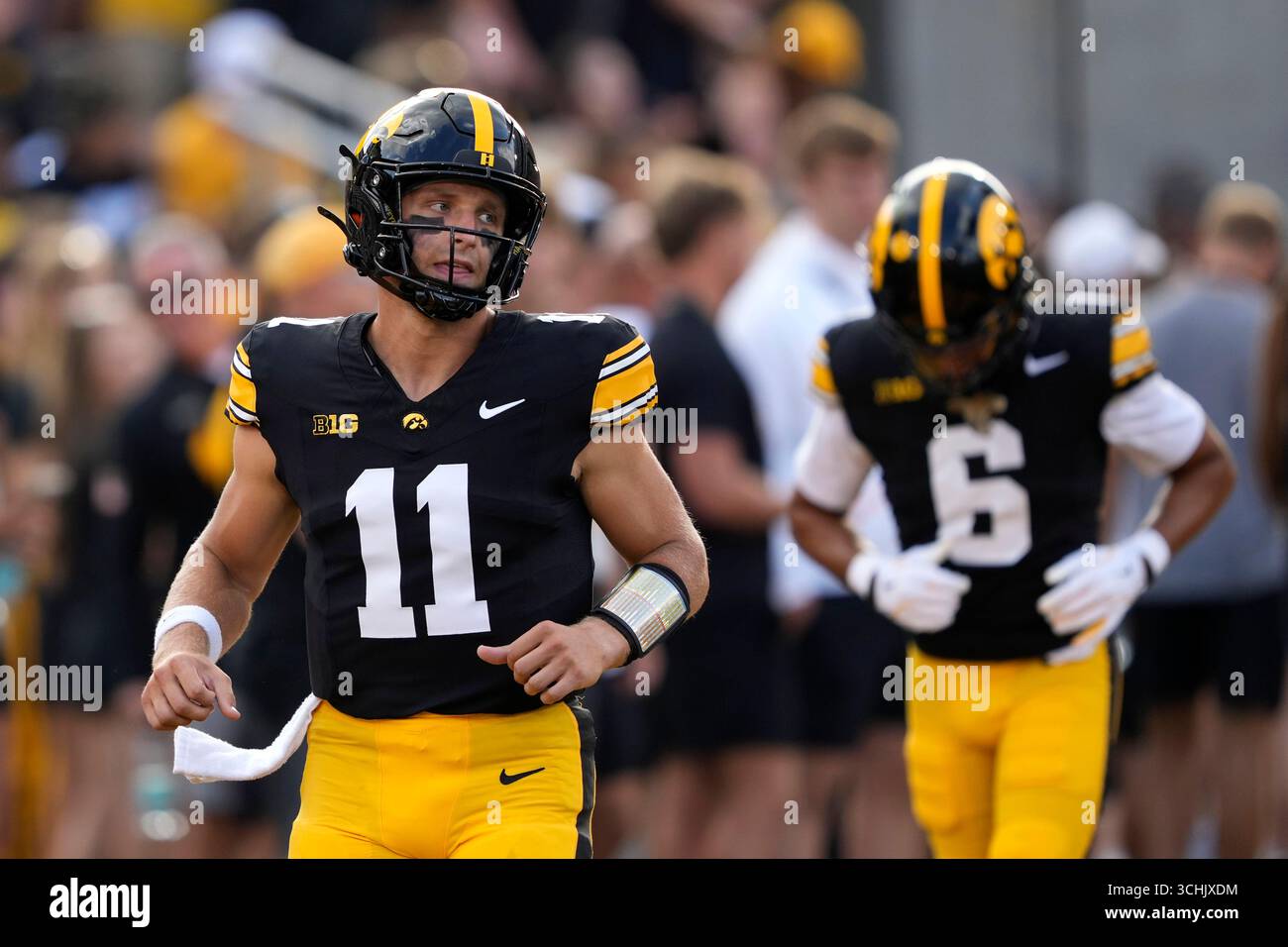Iowa quarterback Mark Gronowski (11) runs onto the field before an NCAA ...