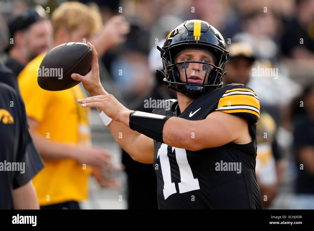 Iowa quarterback Mark Gronowski (11) warms up before an NCAA college ...
