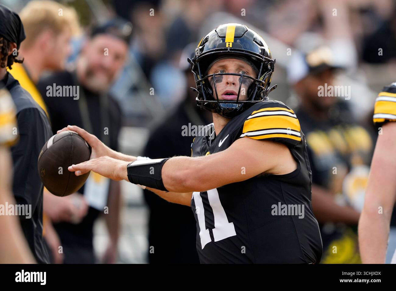 Iowa quarterback Mark Gronowski (11) warms up before an NCAA college ...