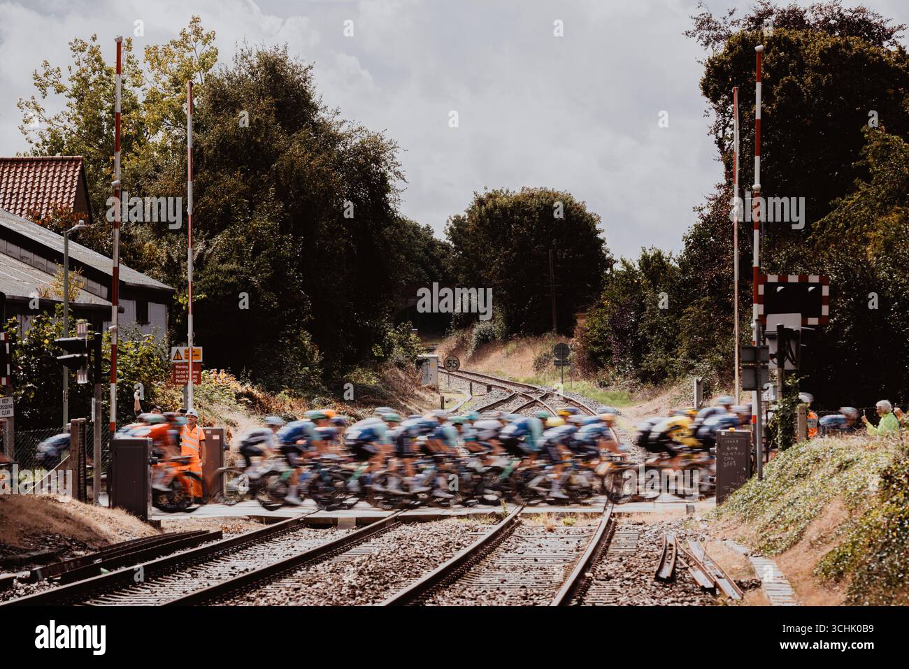 Action from the peloton crossing a level crossing at Saxmundham in ...